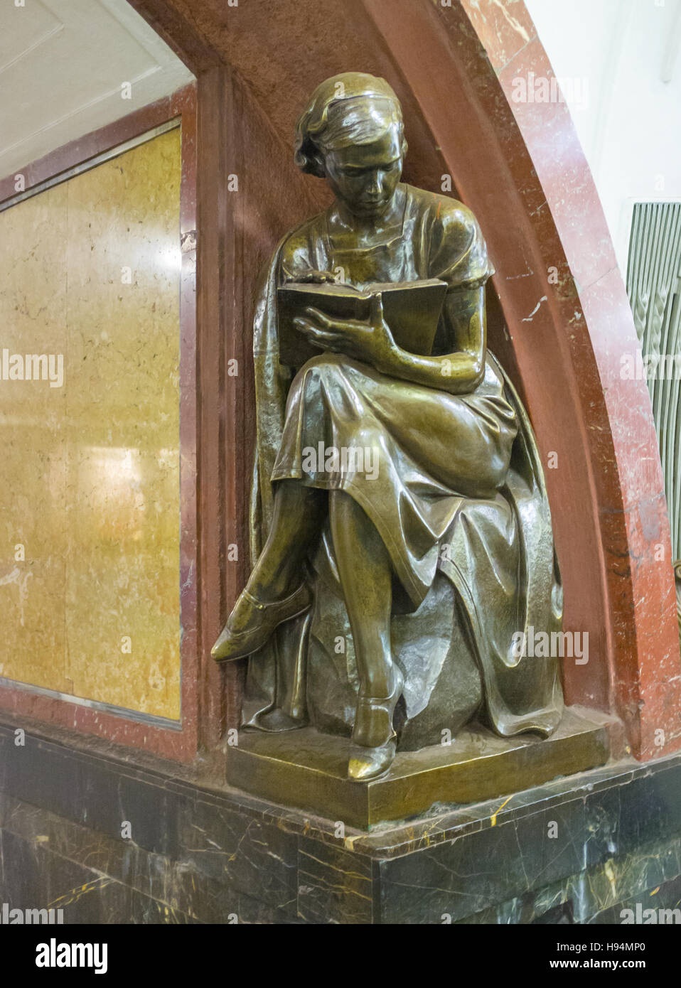 The bronze sculpture of a young woman, reading a book in Revolution ...
