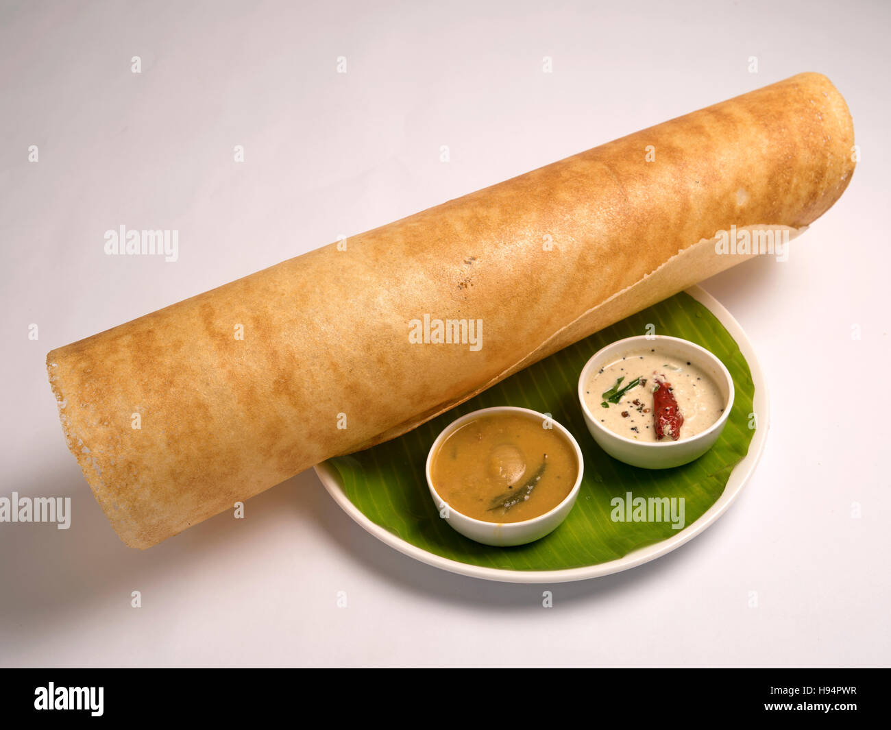 Dosai - crispy rolled roast dosai with sambar and chutney served on ...