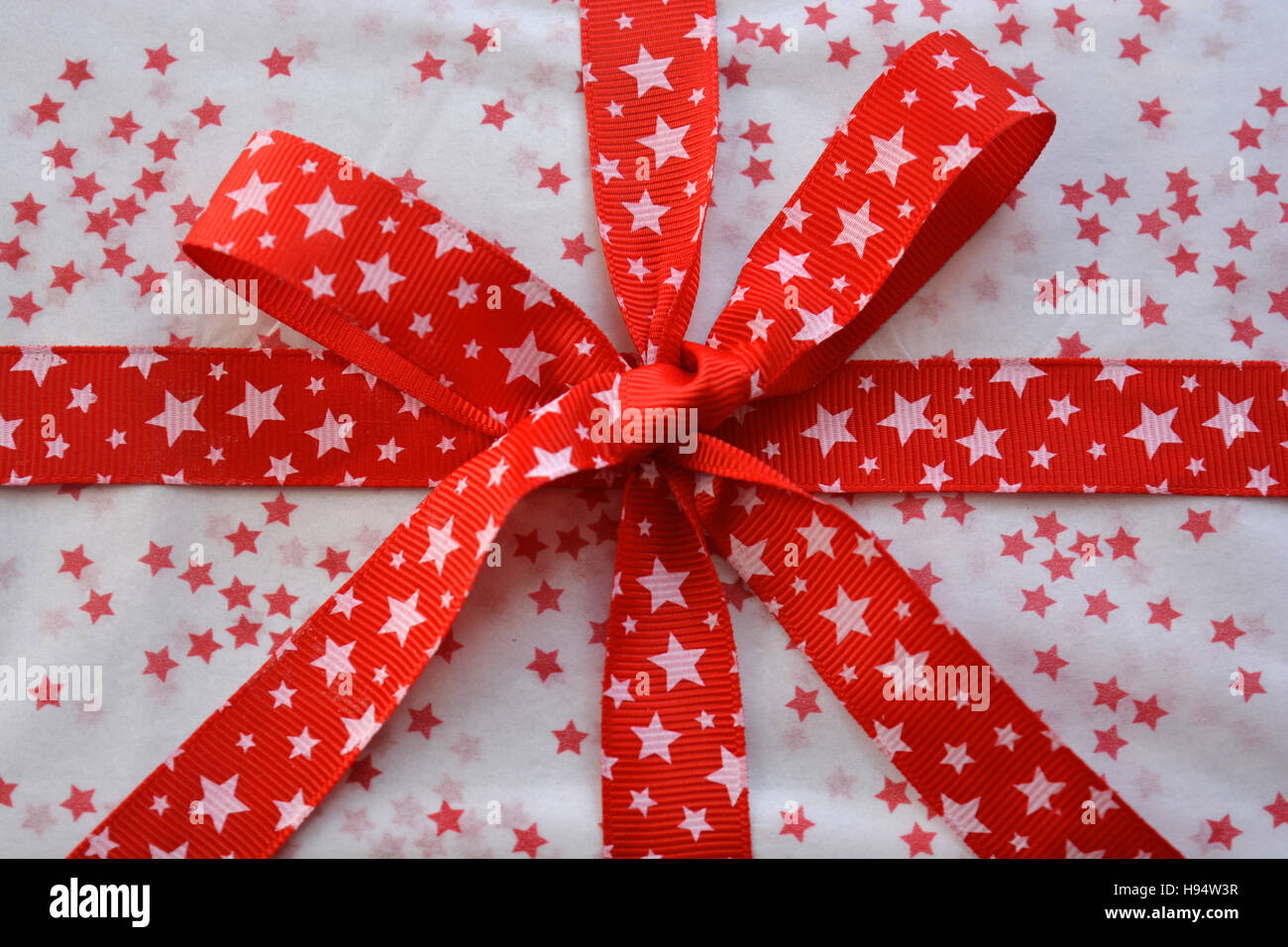 Present, beautifully wrapped and decorated with a red ribbon Stock ...