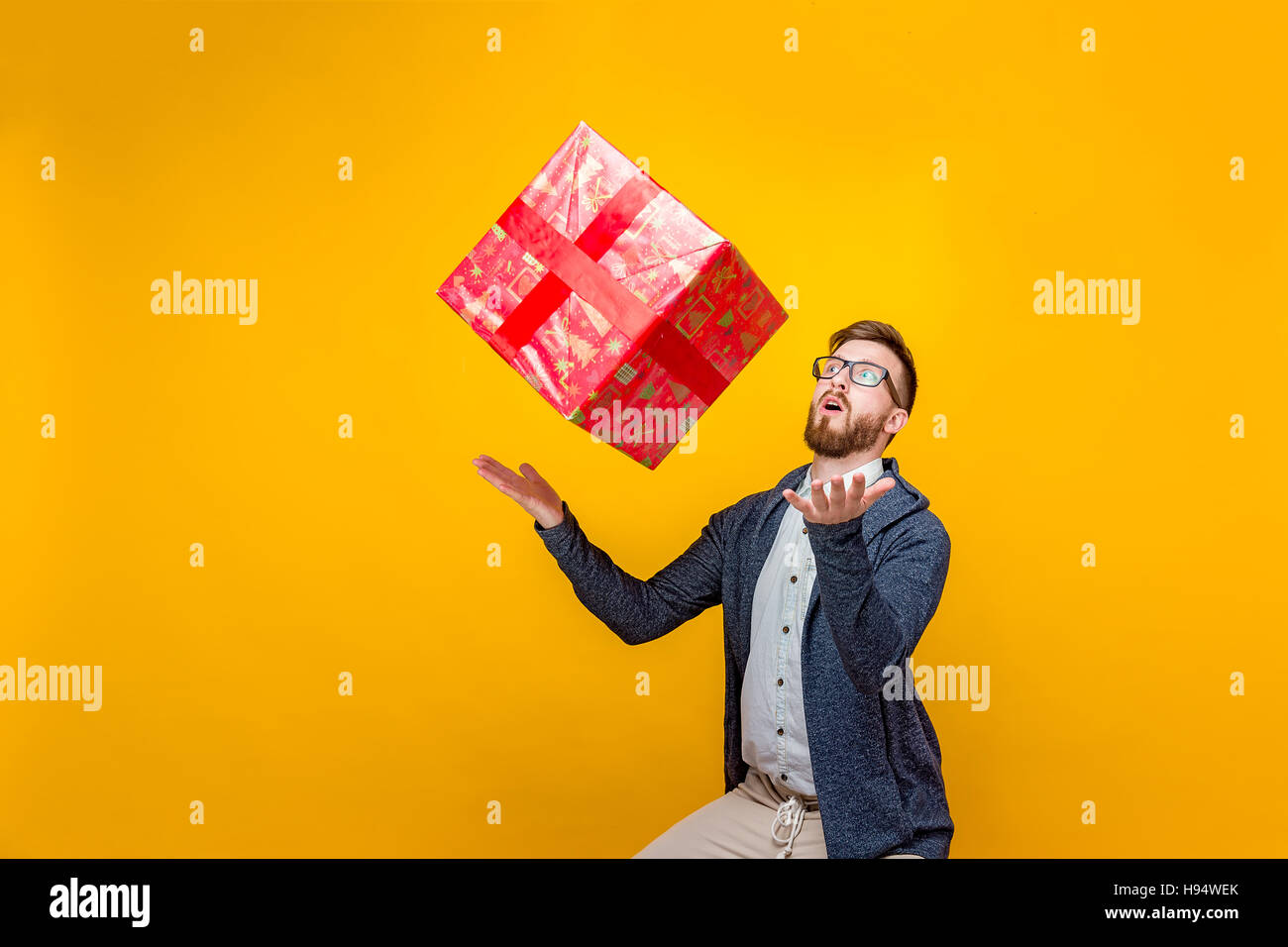 Man throwing present box up Stock Photo - Alamy
