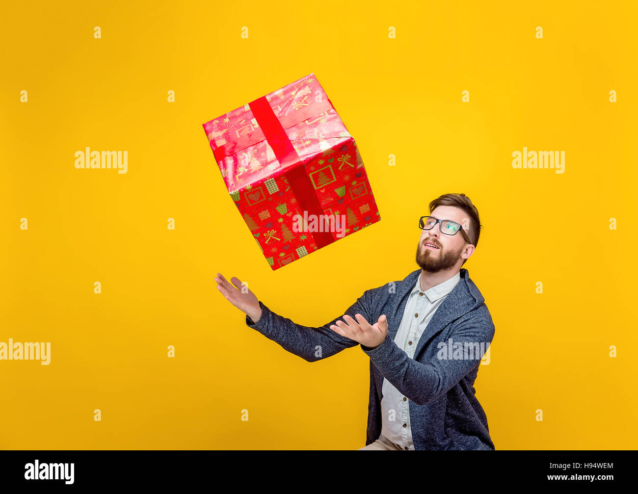 Man throwing present box up Stock Photo - Alamy