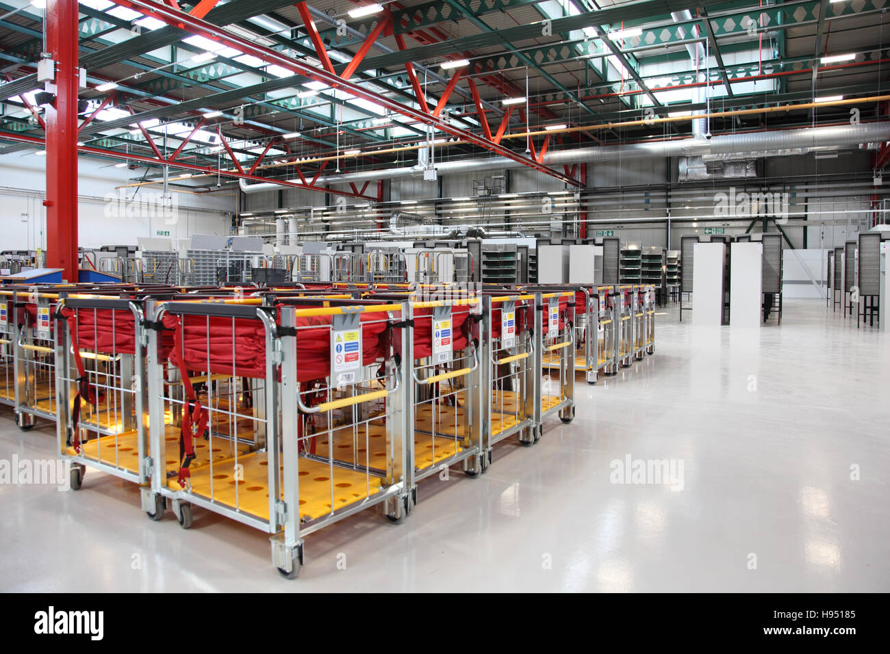 Empty mail trolleys awaiting use in a new Post Office sorting office in ...