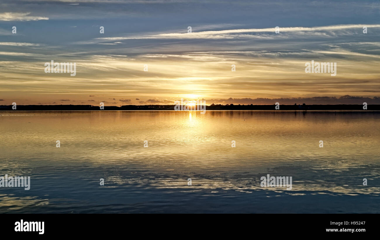 golden sunset on the patria lake in the province of Naples. clouds are ...