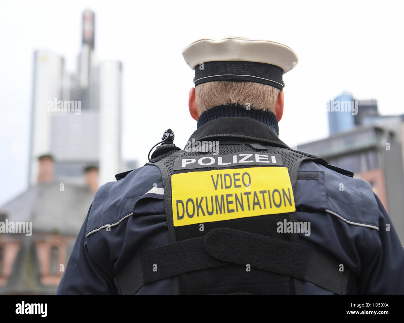 A police officer wearing a video camera on his shoulder and a sign ...