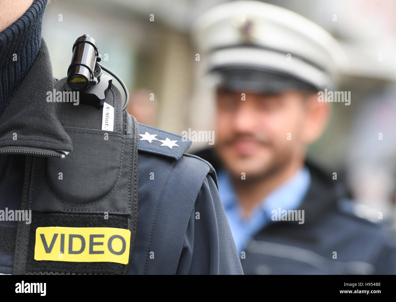 A police officer wearing a video camera on his shoulder in Frankfurt ...