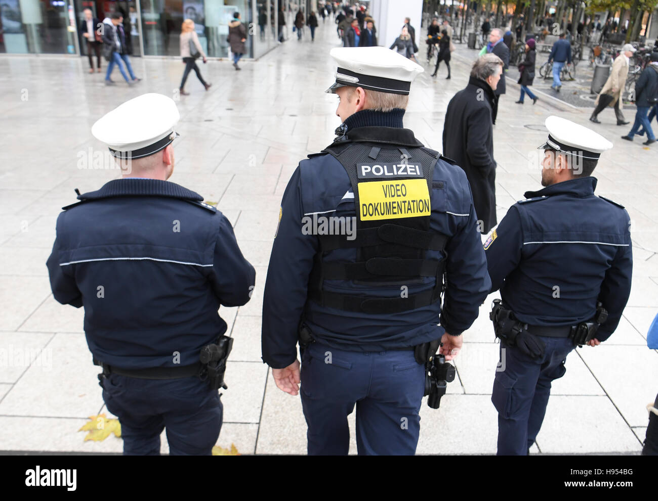 A police officer wearing a video camera on his shoulder (c) inbetween ...