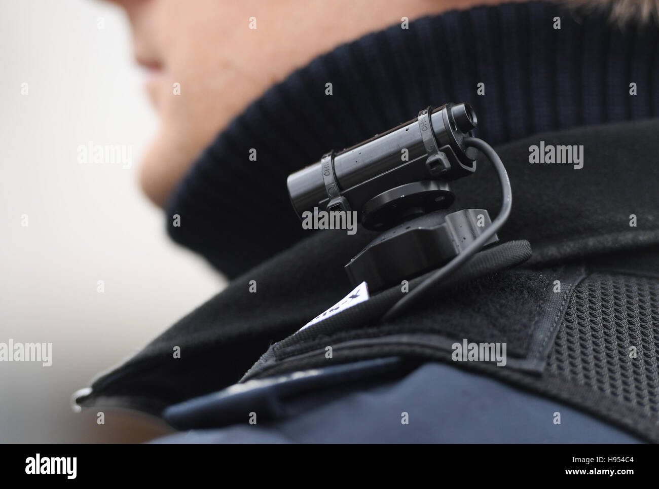 A police officer wearing a video camera on his shoulder in Frankfurt ...
