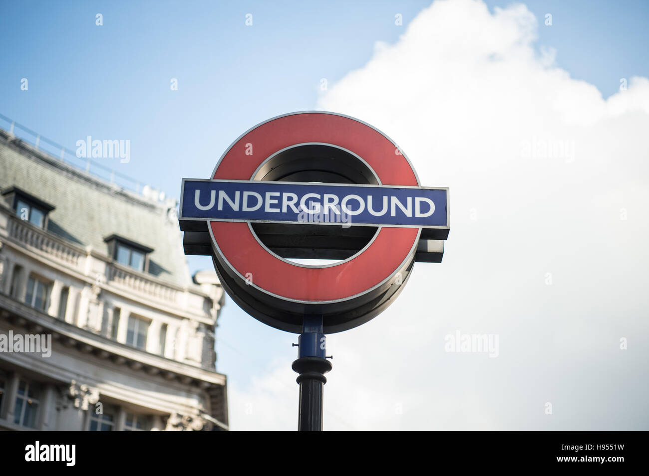 An entrance to an underground train station with a sign above it that ...