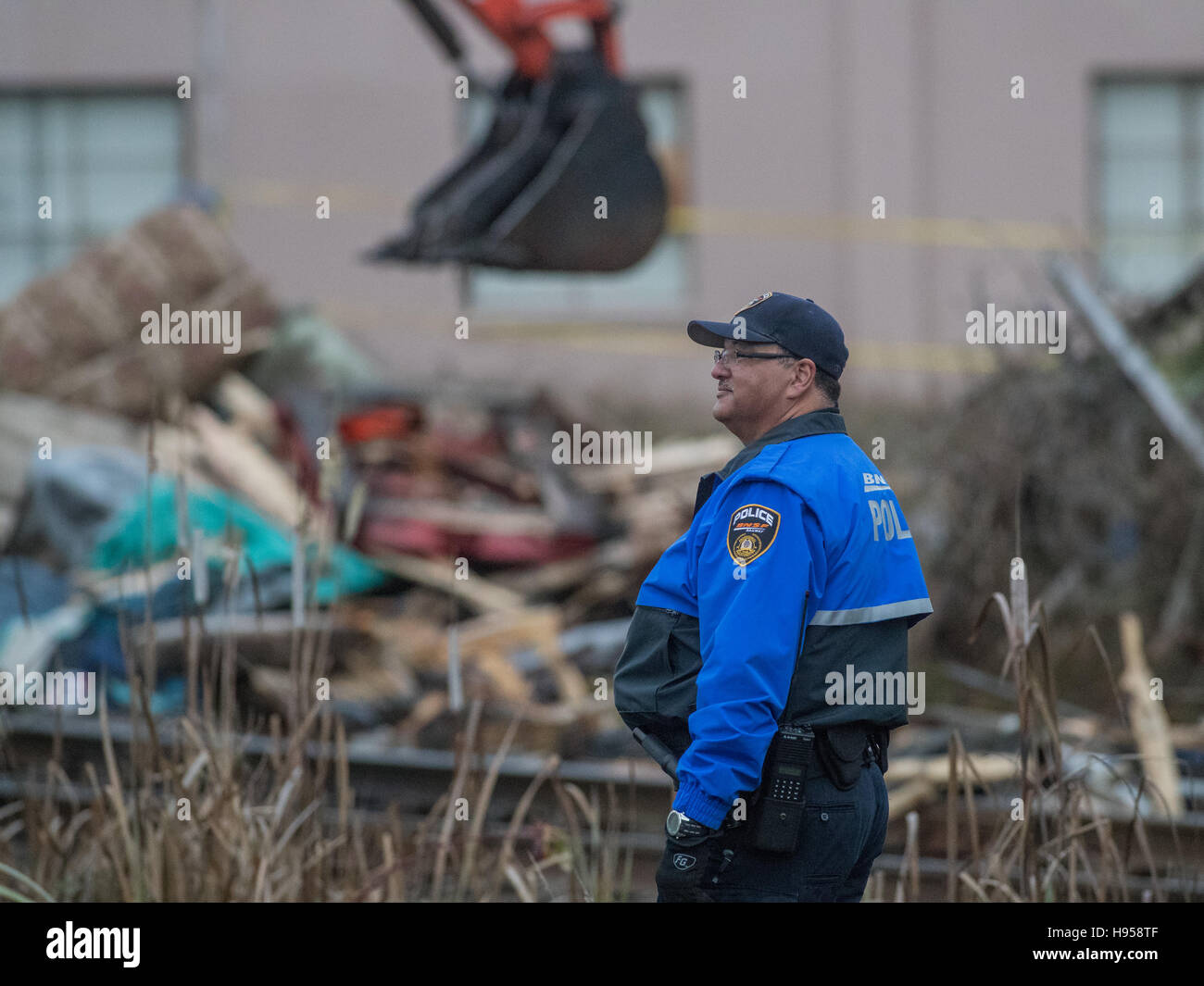 BNSF railway police looks on as tracks are cleared of debris after the ...