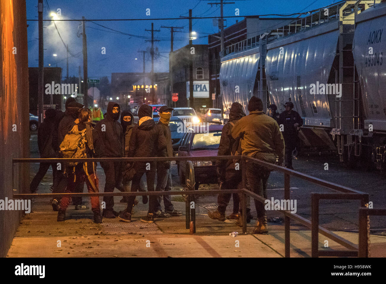 Protestors look on as police escort train carrying Proppants (ceramic ...