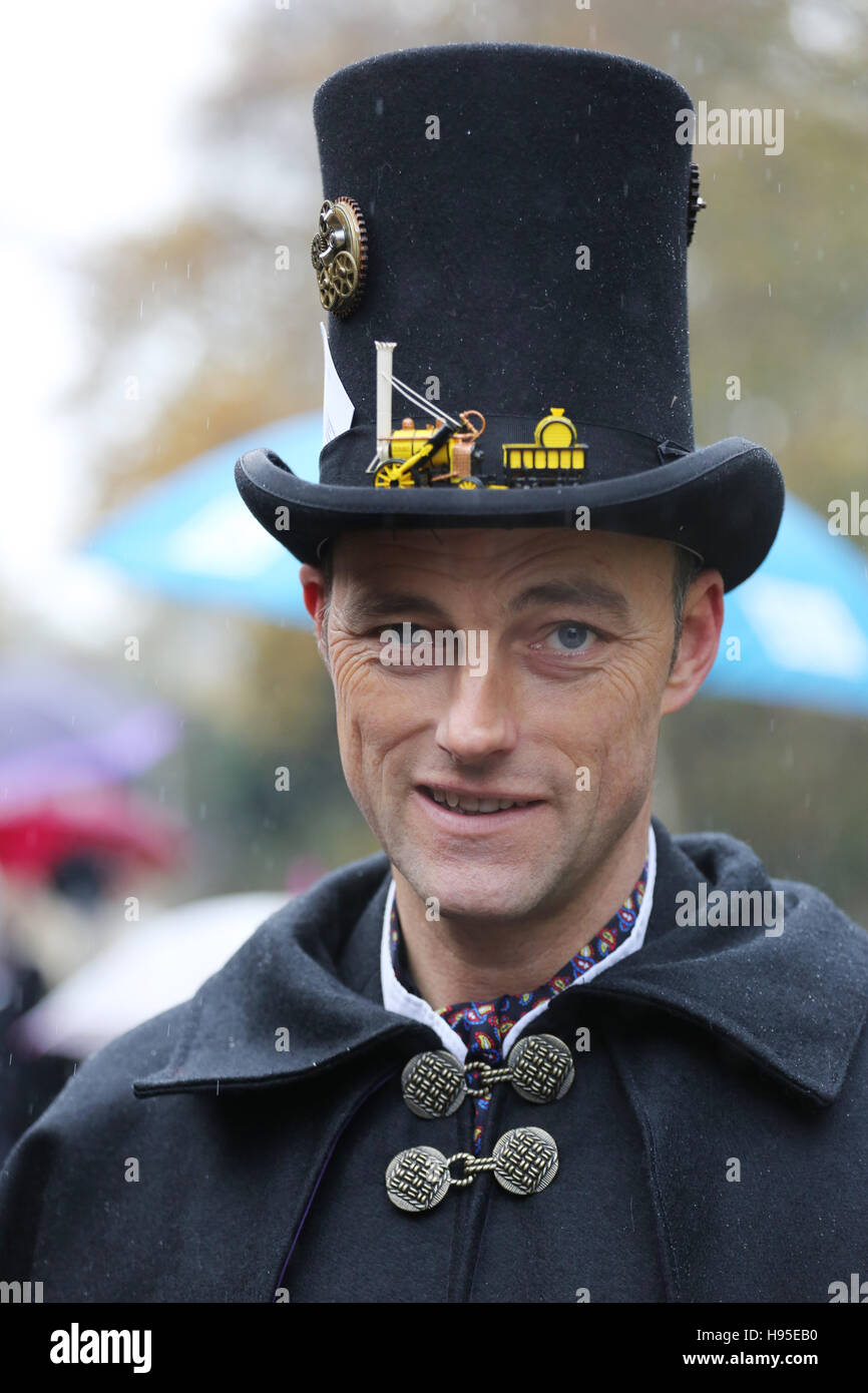 Haworth, UK. 19th Nov, 2016. A man wearing a top hat with a steam train ...