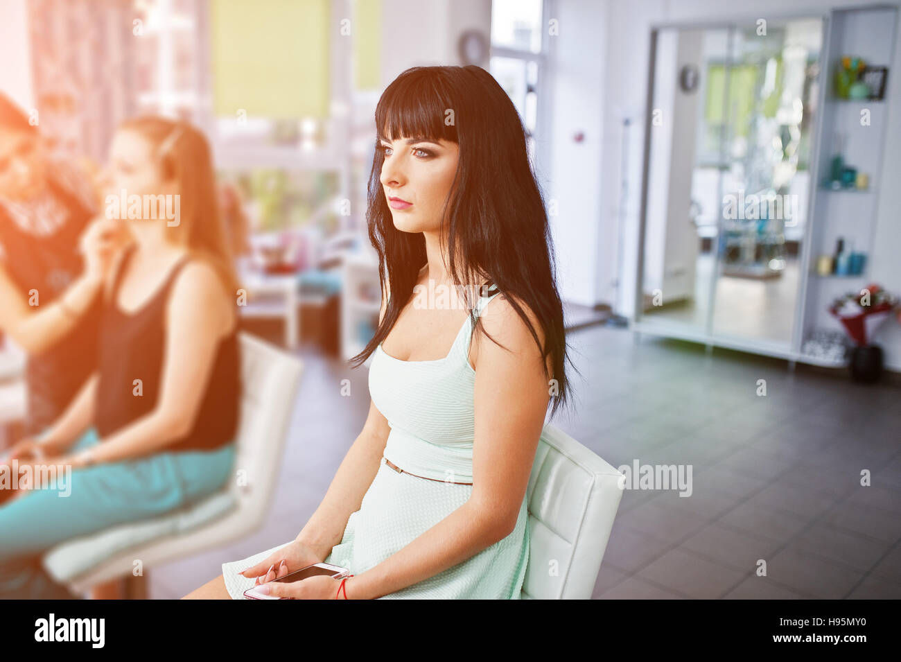 Professional make- up artist applying makeup on a beautiful brunette ...