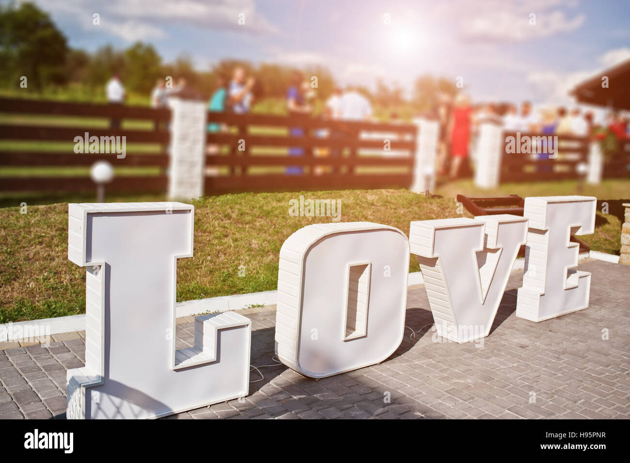 Big word LOVE on wedding ceremony background guests Stock Photo - Alamy