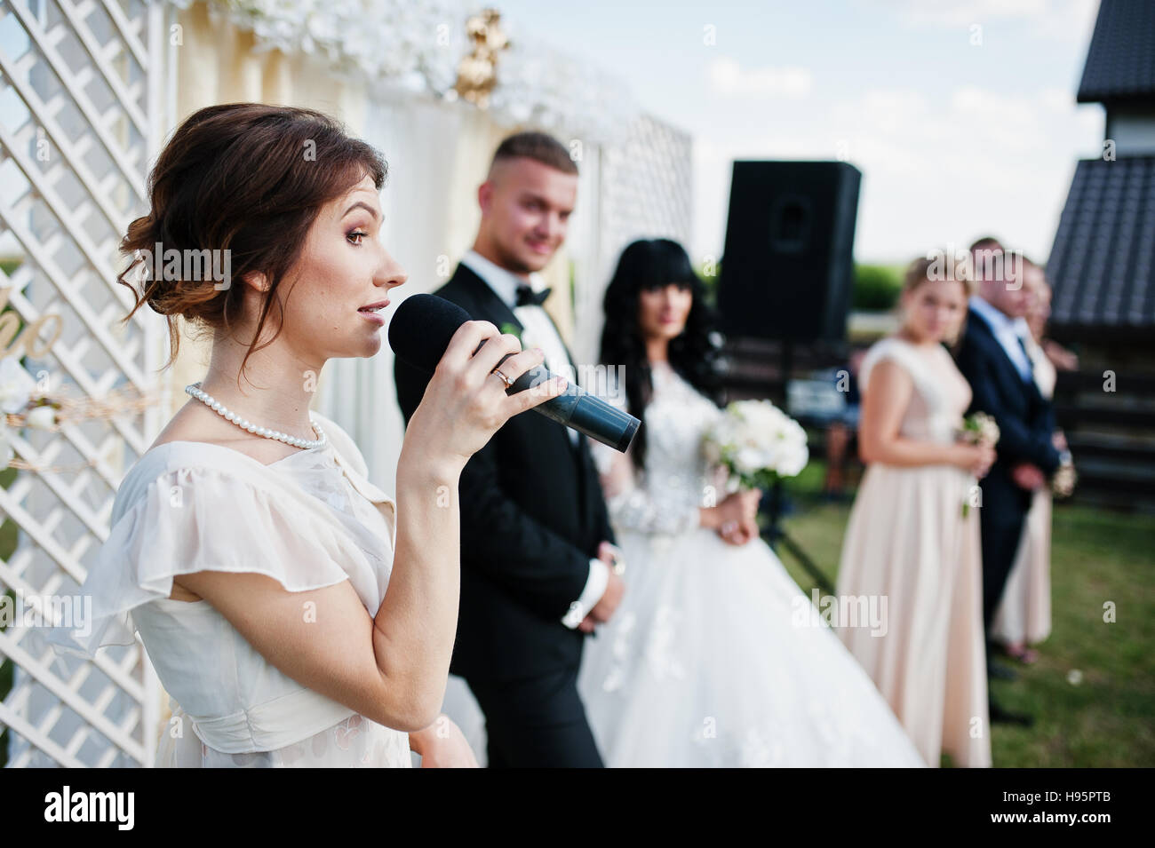 Master of ceremony speech on microphone background wedding couple Stock ...