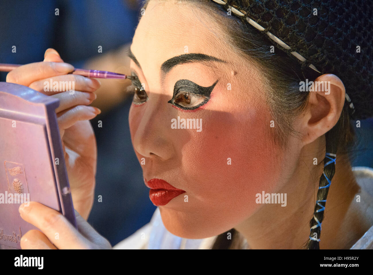 Chinese opera performer putting on a makeup at the Vegetarian Festival ...