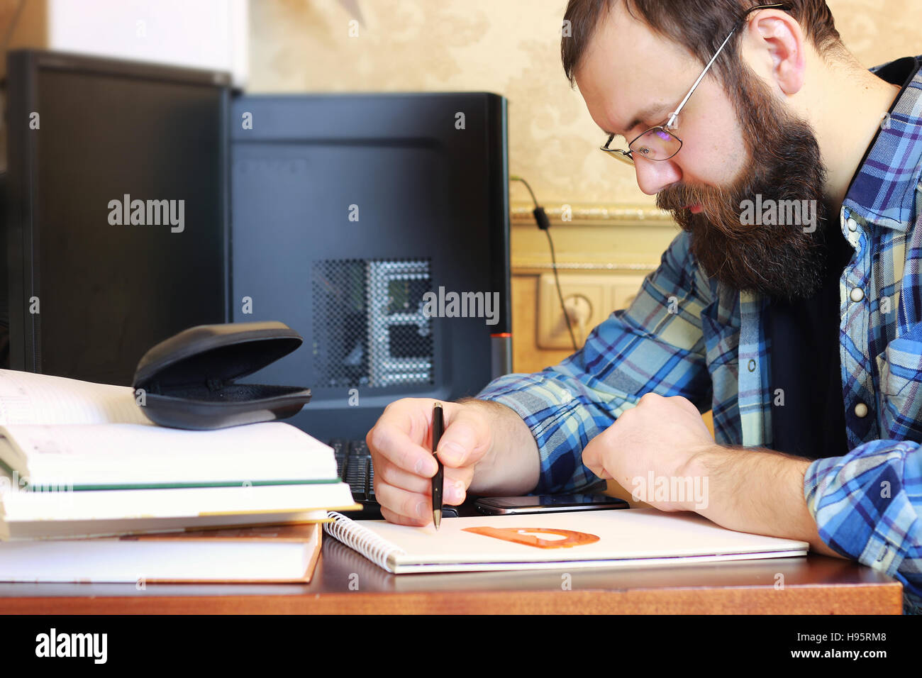man write pen table Stock Photo - Alamy
