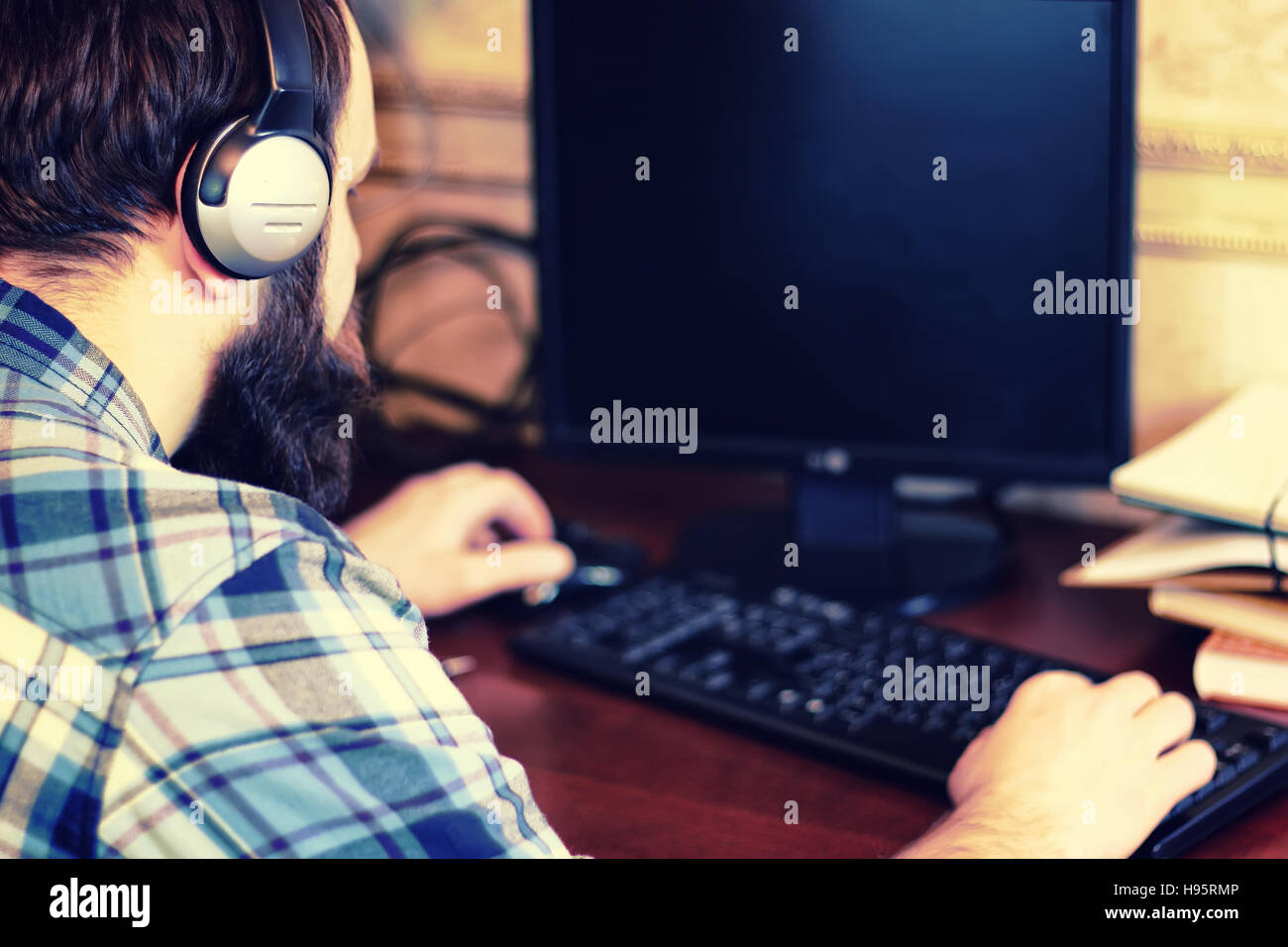 male behind computer with headphones Stock Photo - Alamy