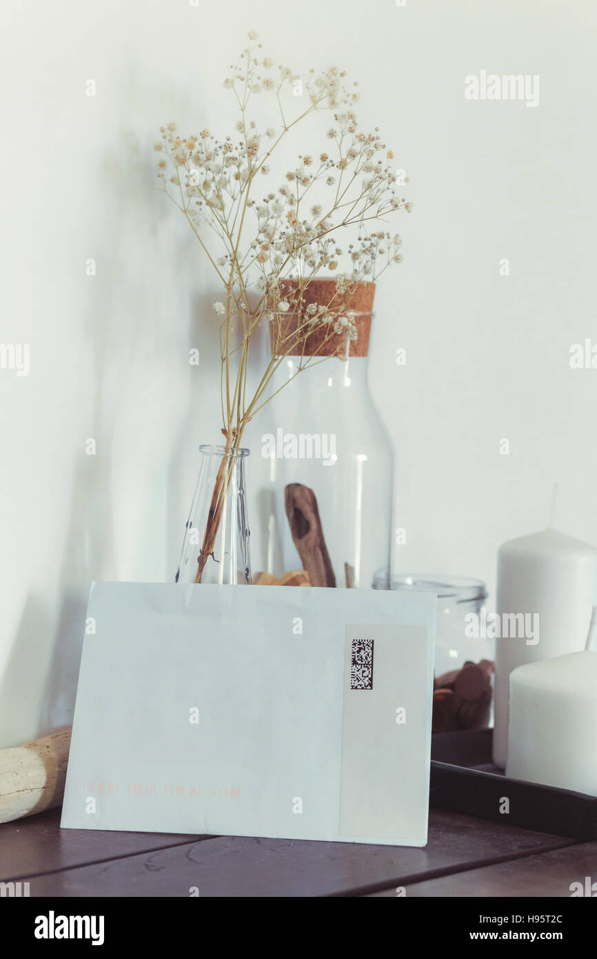 A postal envelope over a wood furniture table on feminine set Stock ...