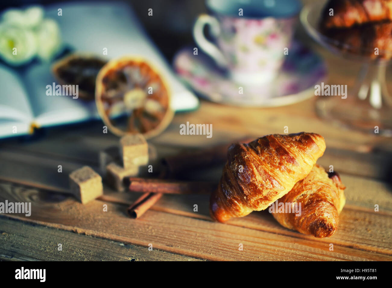 tea cup croissant book Stock Photo - Alamy