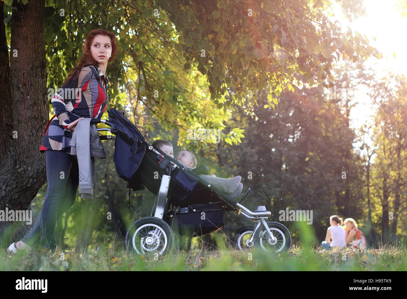 walk women with stroller summer sunlight Stock Photo - Alamy