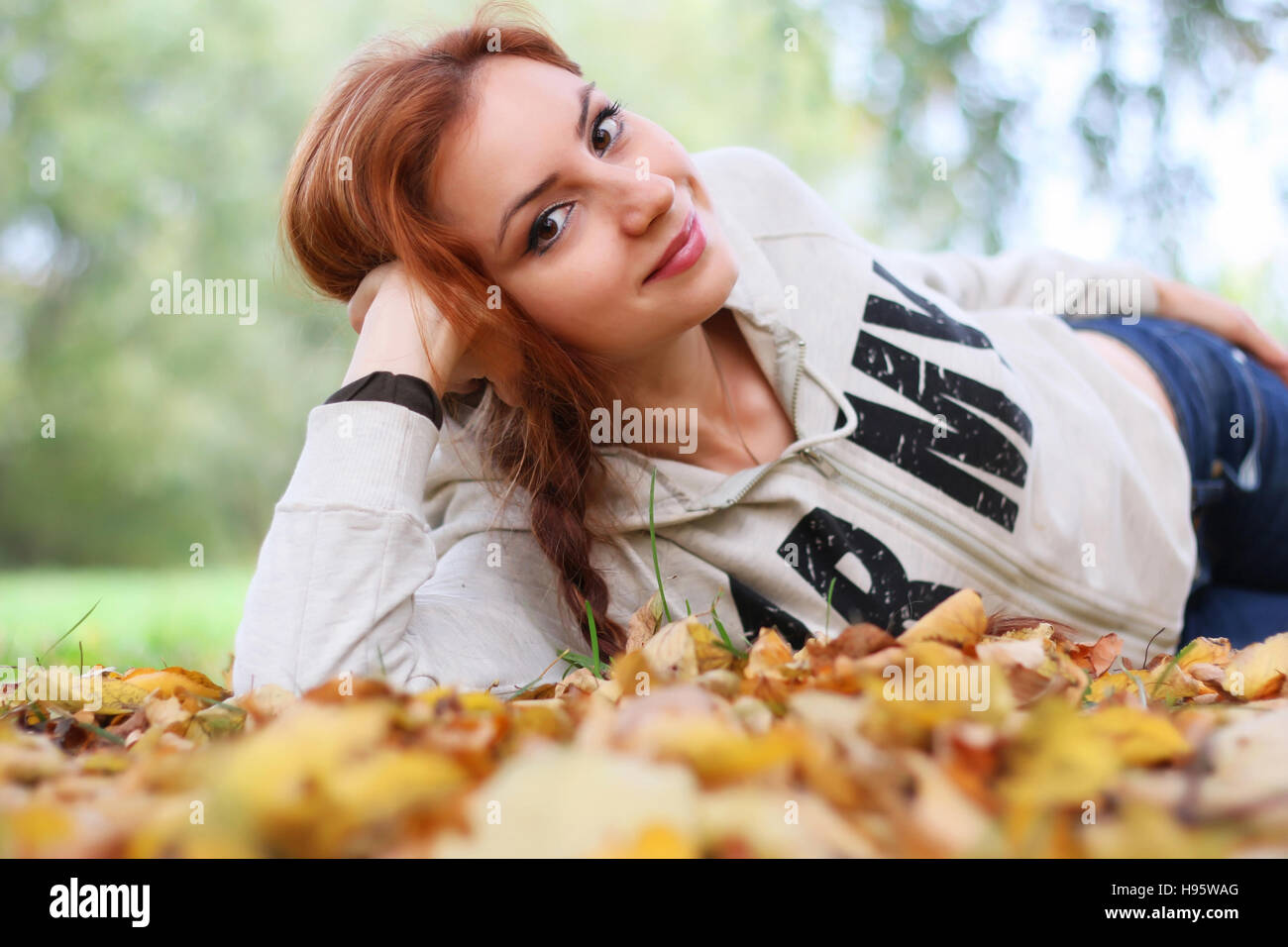 Autumn leaves girl book casual Stock Photo - Alamy