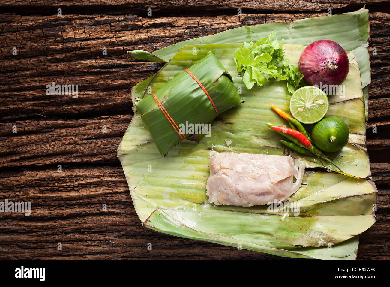 nham sour pork in banana leaves thai food rustic on wooden background ...
