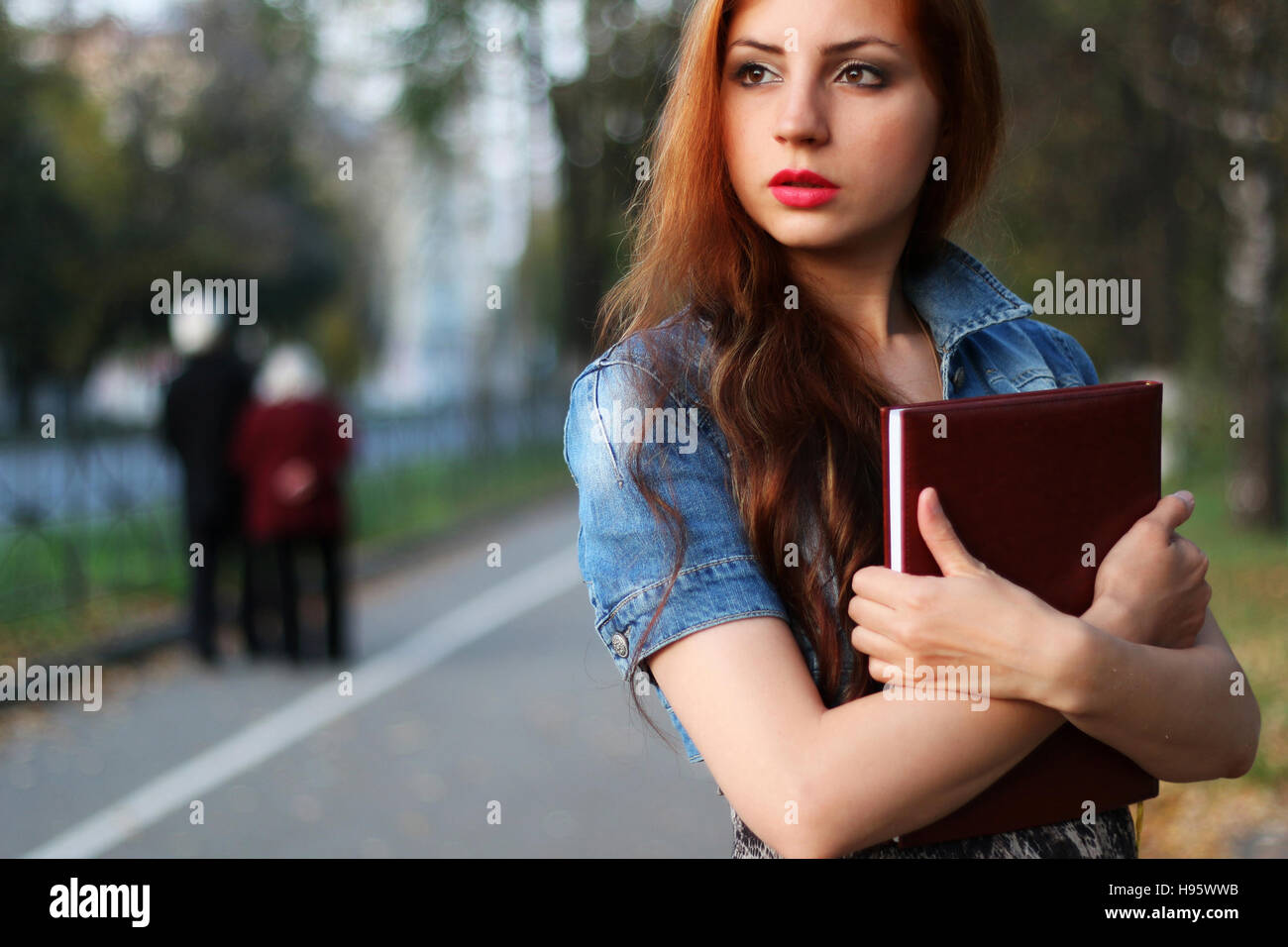 red-haired girl dress folder with documents Stock Photo - Alamy