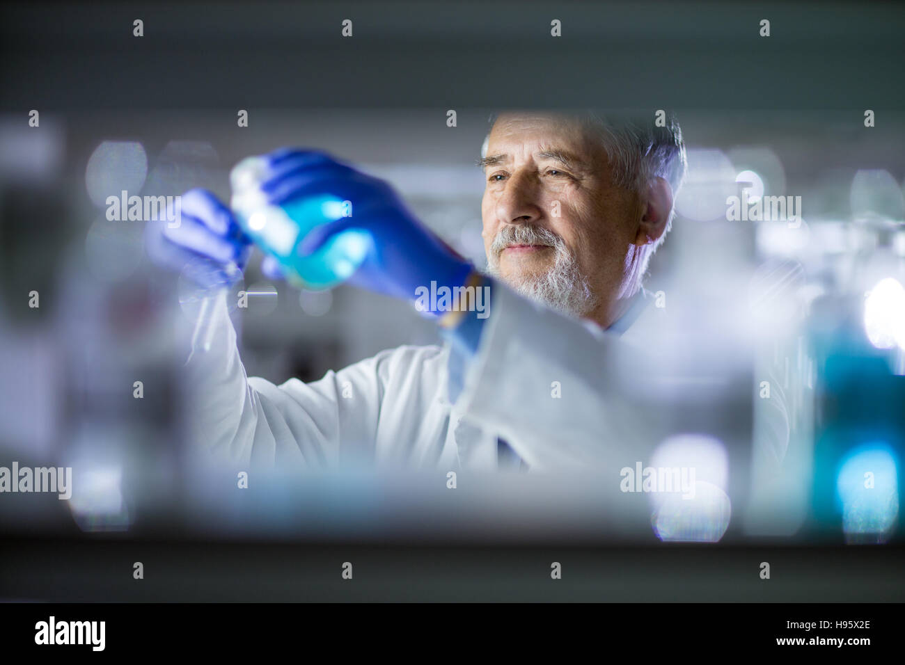 Senior male researcher carrying out scientific research in a lab ...