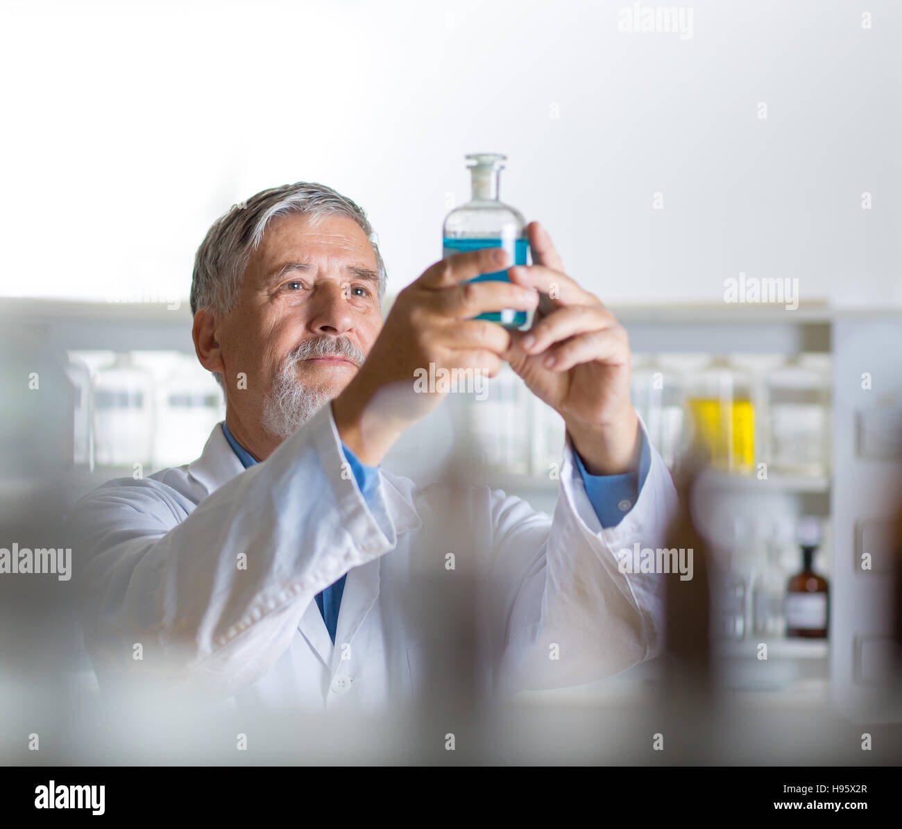 Senior male researcher carrying out scientific research in a lab ...