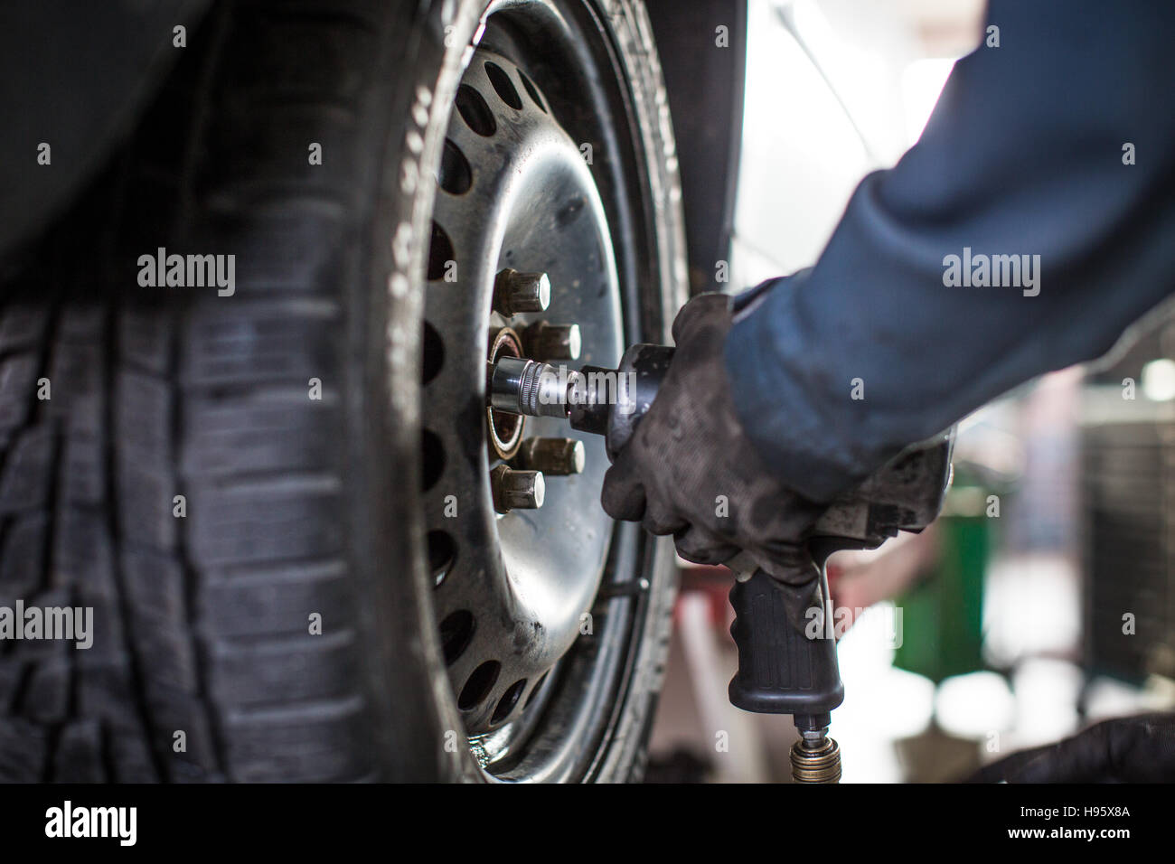 Inside a garage - changing wheels/tires (shallow DOF; color toned image ...
