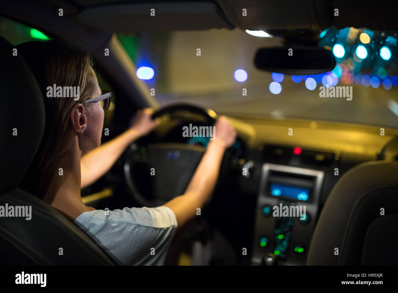 Female drive driving a car at night Stock Photo - Alamy