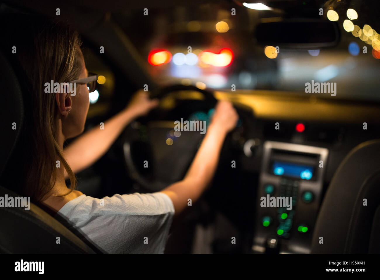 Female drive driving a car at night Stock Photo - Alamy