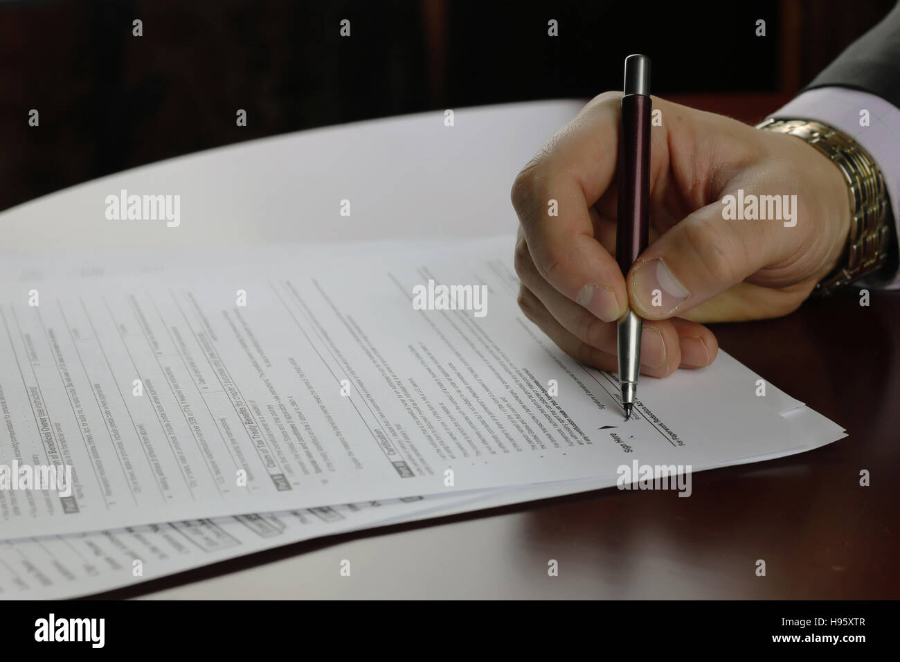hand signed tax form Stock Photo - Alamy