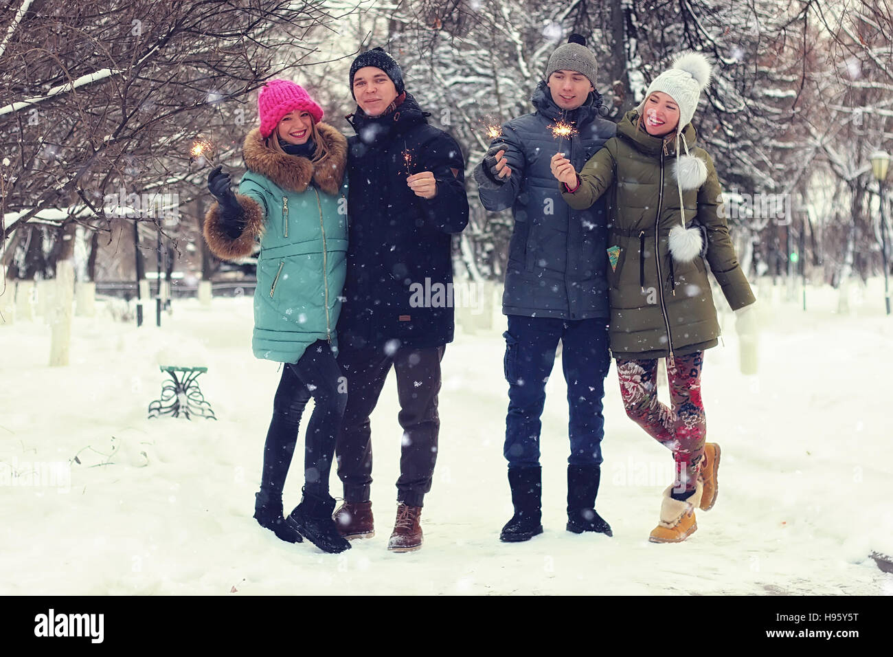winter group of young people with sparklers Stock Photo - Alamy