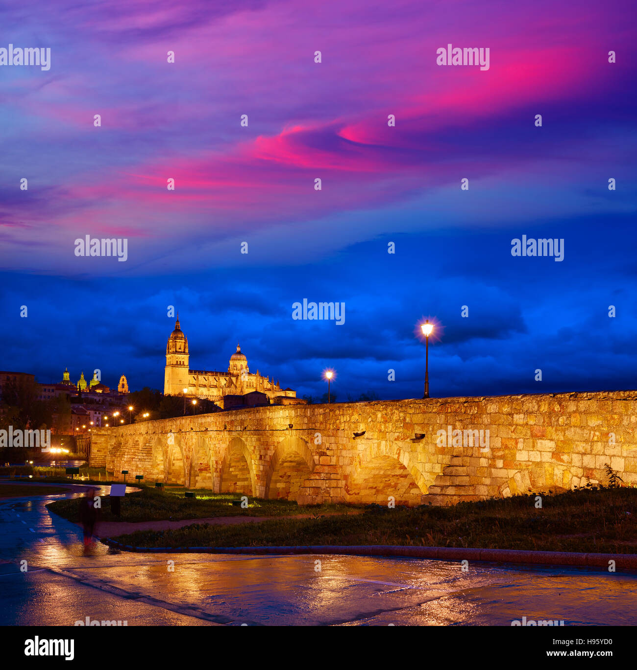 Salamanca skyline sunset and roman bridge over Tormes river in Spain ...