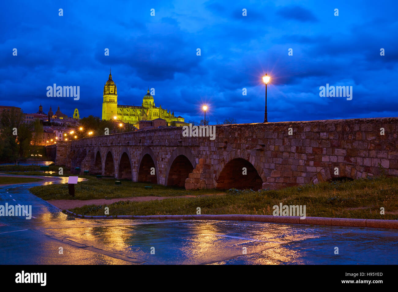 Salamanca skyline sunset and roman bridge over Tormes river in Spain ...