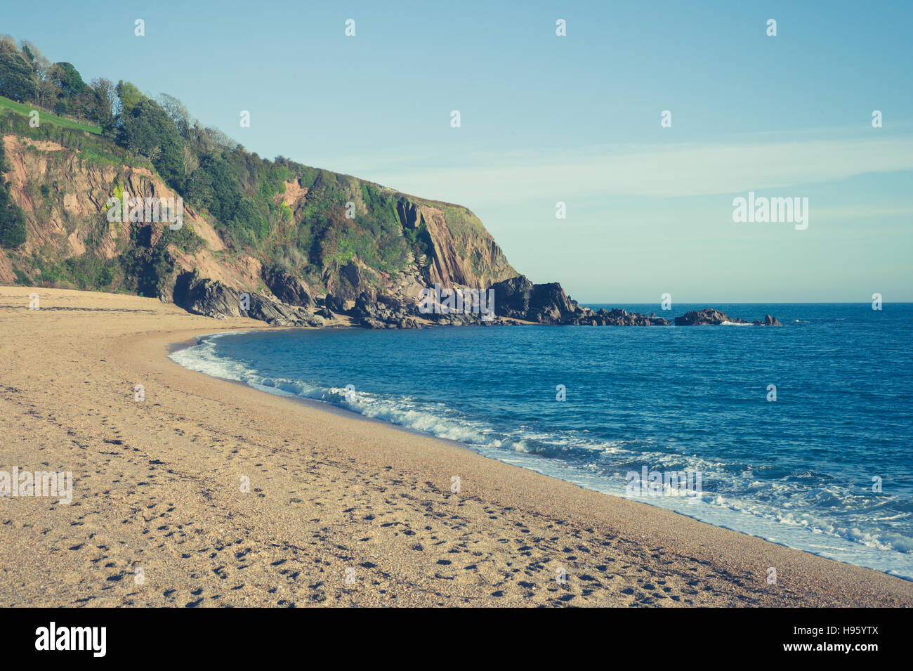 A beautiful beach with cliffs on a sunny day Stock Photo - Alamy