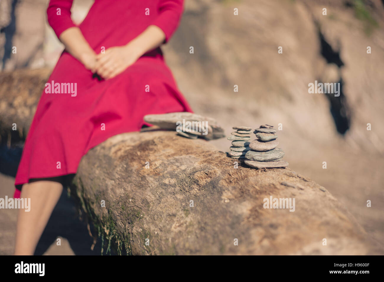 Closeup on a small bunch of rocks placed in formation with a woman in ...