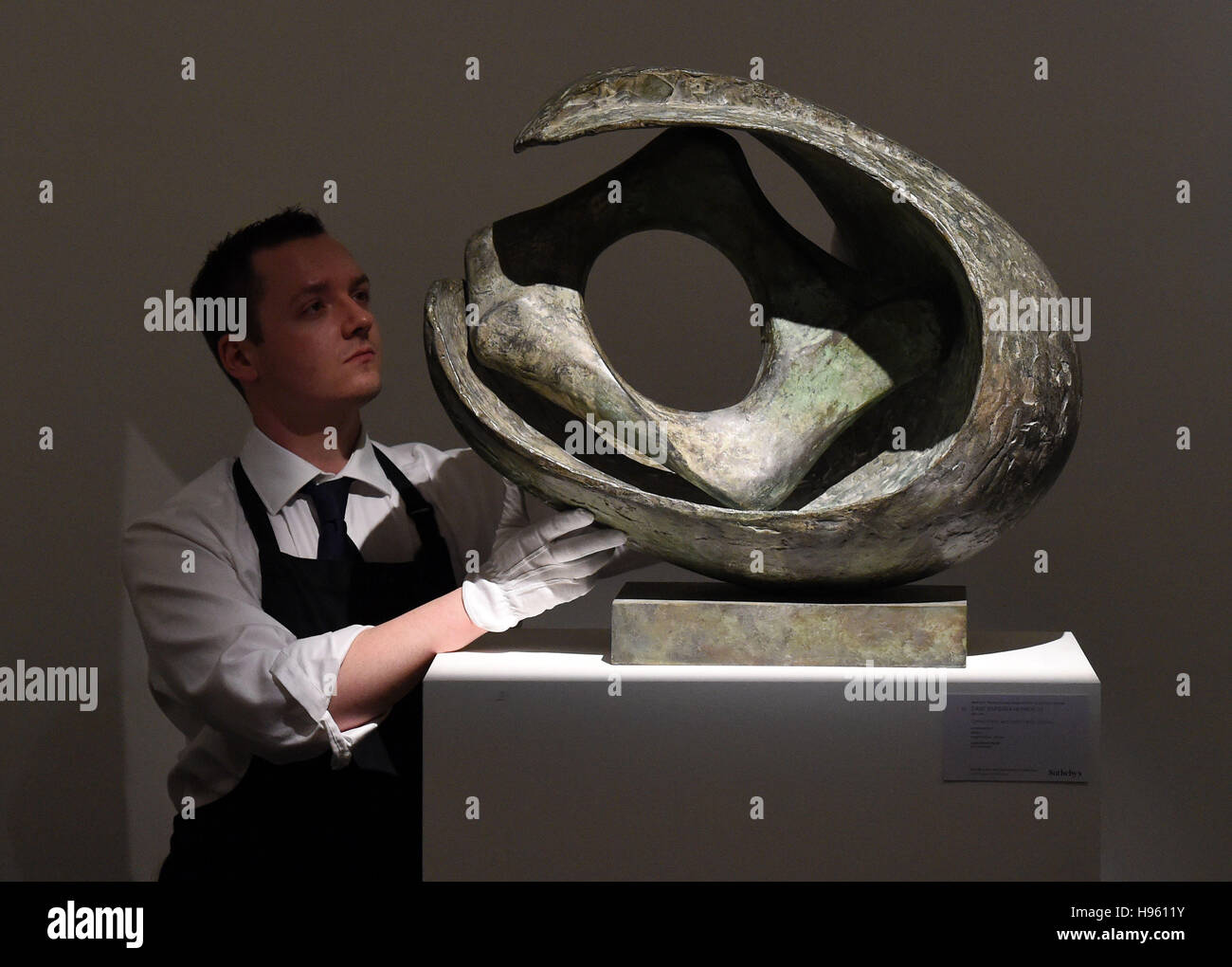 Staff at Sotheby's, London, adjust a sculpture titled Curved Form With ...