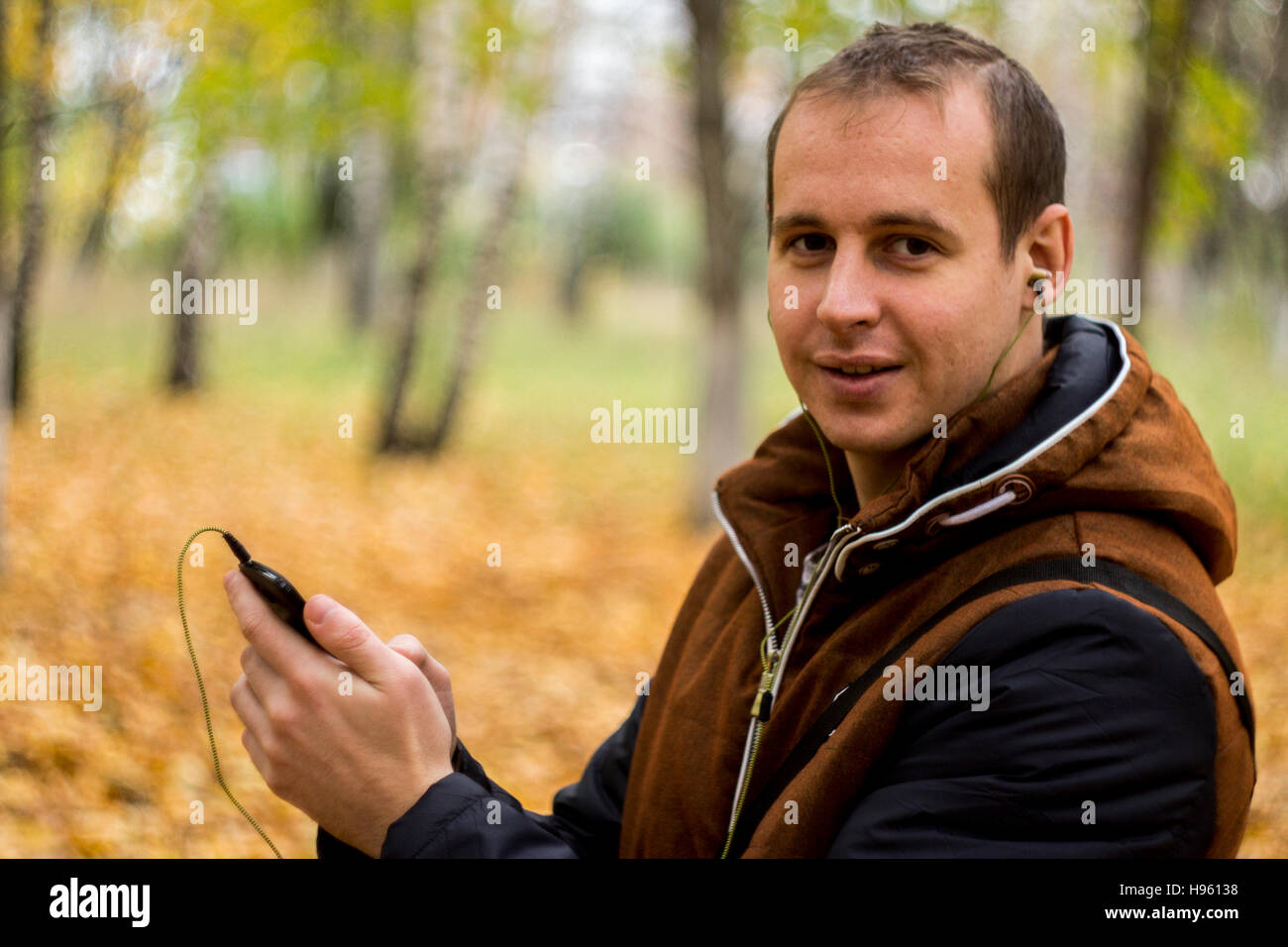Young man listening to music on smartphone Stock Photo - Alamy