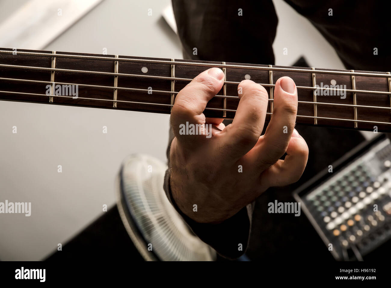 A rock musician playing the bass in a rehearsal room Stock Photo - Alamy