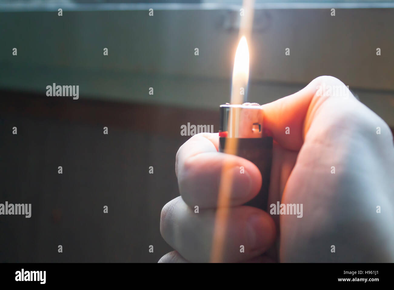 burning lighter in the hand of man Stock Photo - Alamy