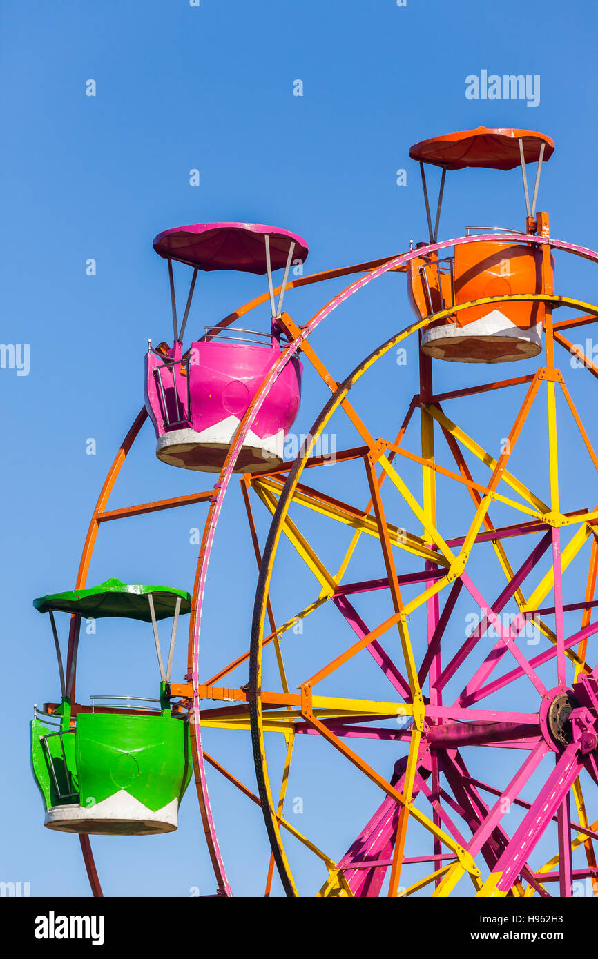 Amusement playground ferris wheel with three cabin pods in blue sky ...
