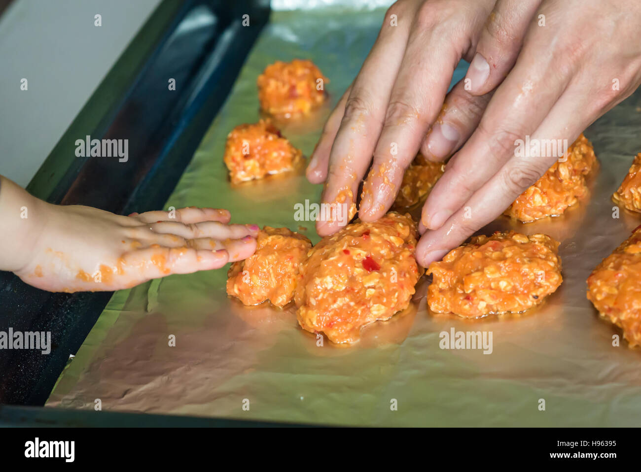 Children and dad hands put the meatballs Stock Photo - Alamy