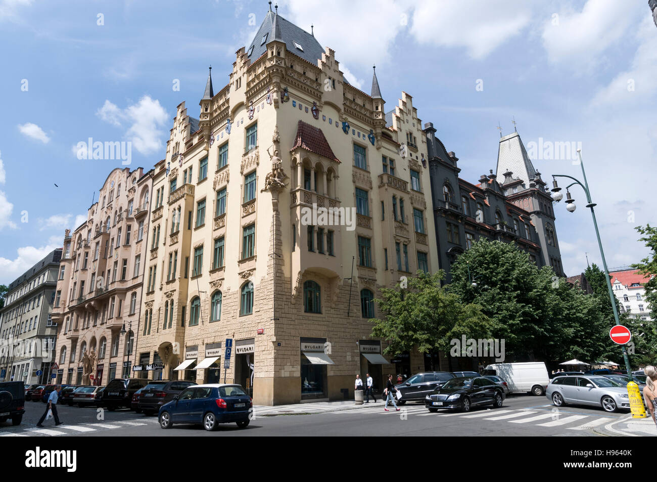 A tall Gothic designed building with a row of ornamented shields on its ...