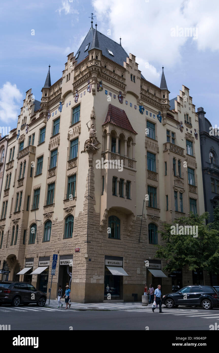 A tall Gothic designed building with a row of ornamented shields on its ...