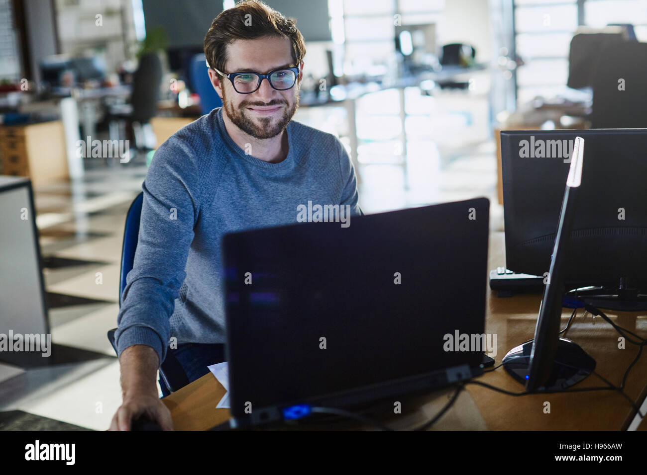 Portrait smiling businessman working at computer in office Stock Photo ...