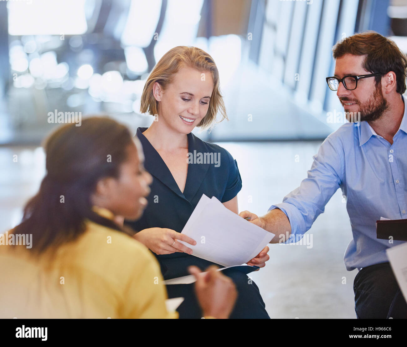 Business people discussing paperwork in meeting Stock Photo - Alamy