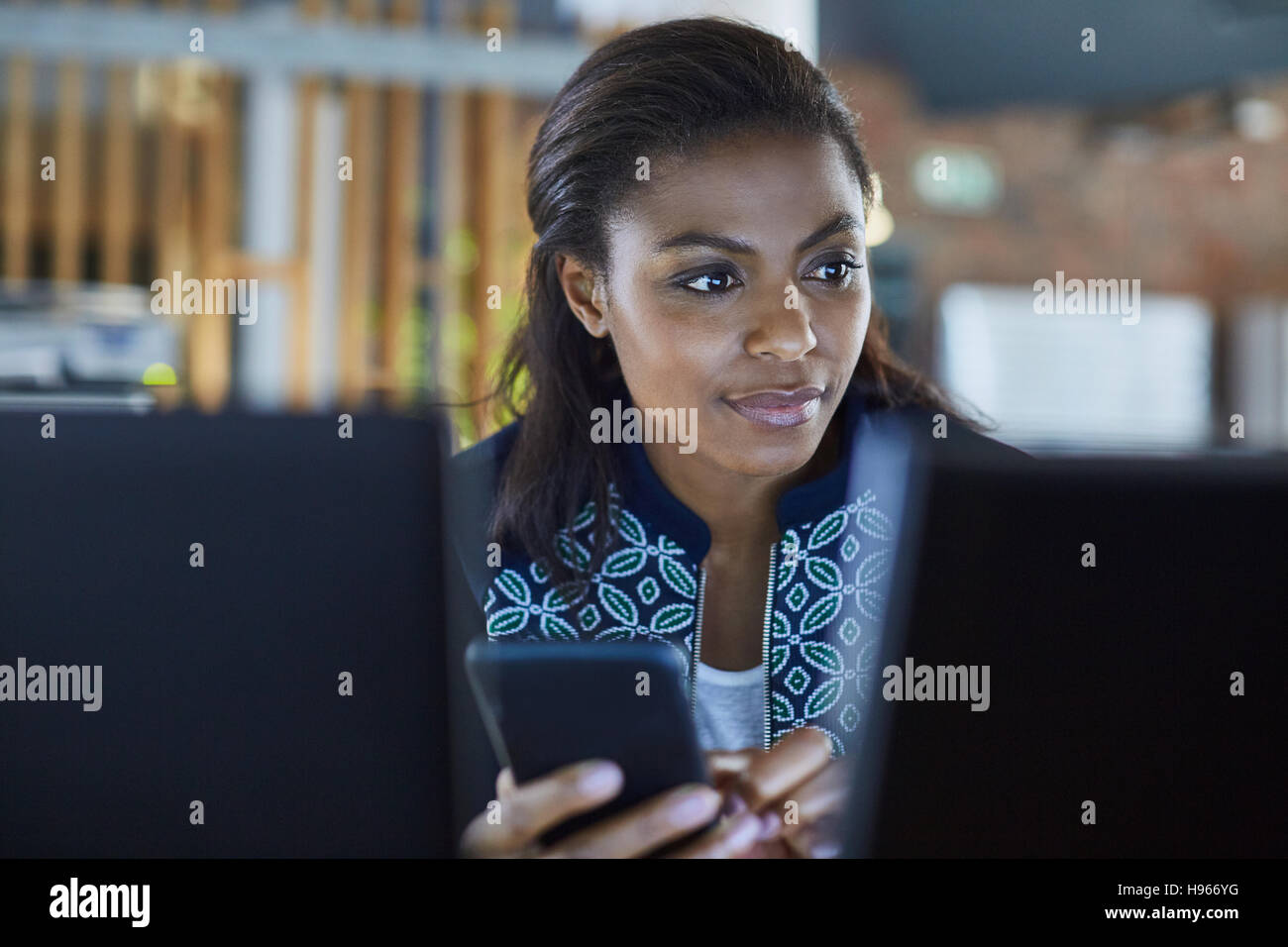 Businesswoman texting at computer in office Stock Photo - Alamy