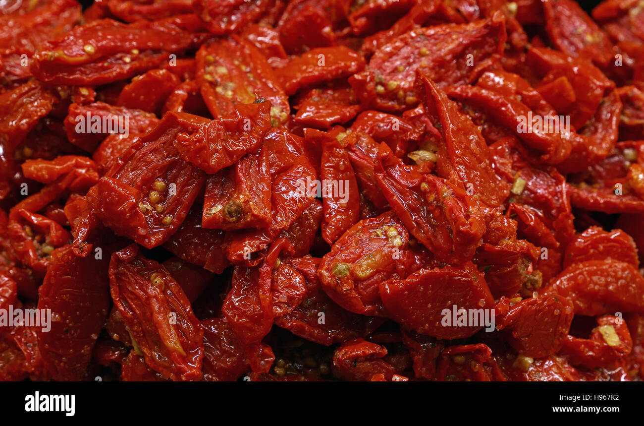 Sundried cured red tomatoes on retail fresh food market stall display ...